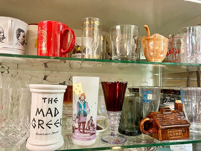 "The Mad Greek" mug sits among vintage glassware like characters at a reunion of discontinued dinnerware. Each has a story to tell.