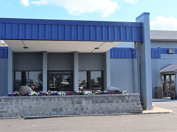 Blue awnings and flower boxes add a splash of color to this local establishment, proving small towns understand curb appeal better than any HGTV show.