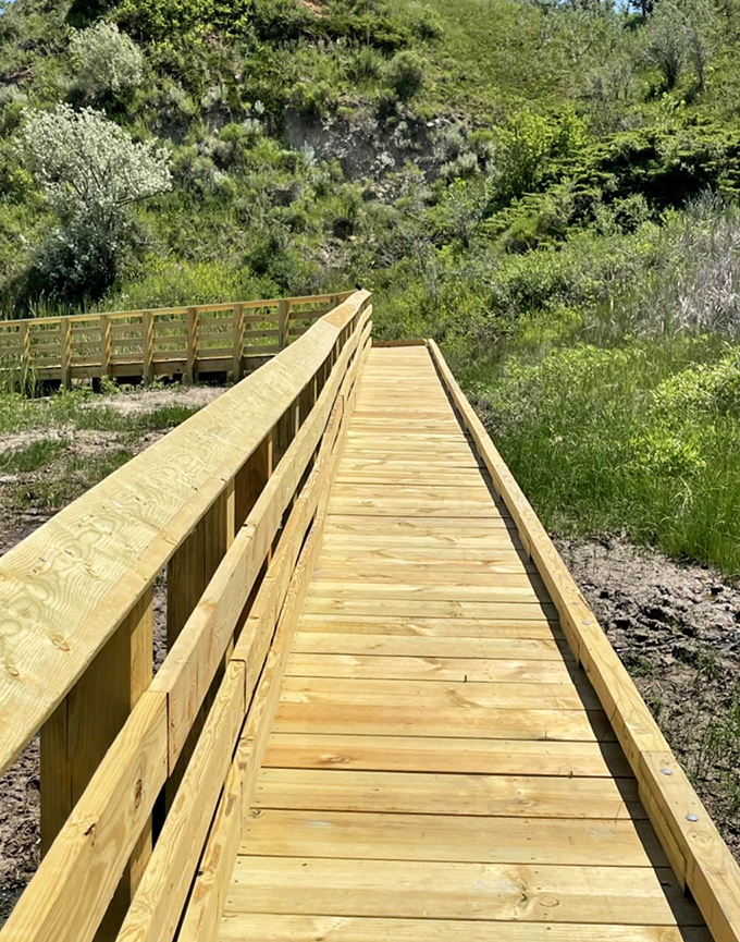 A freshly constructed wooden walkway invites exploration through prairie terrain. Your stairway to heaven is actually a flat path in North Dakota.