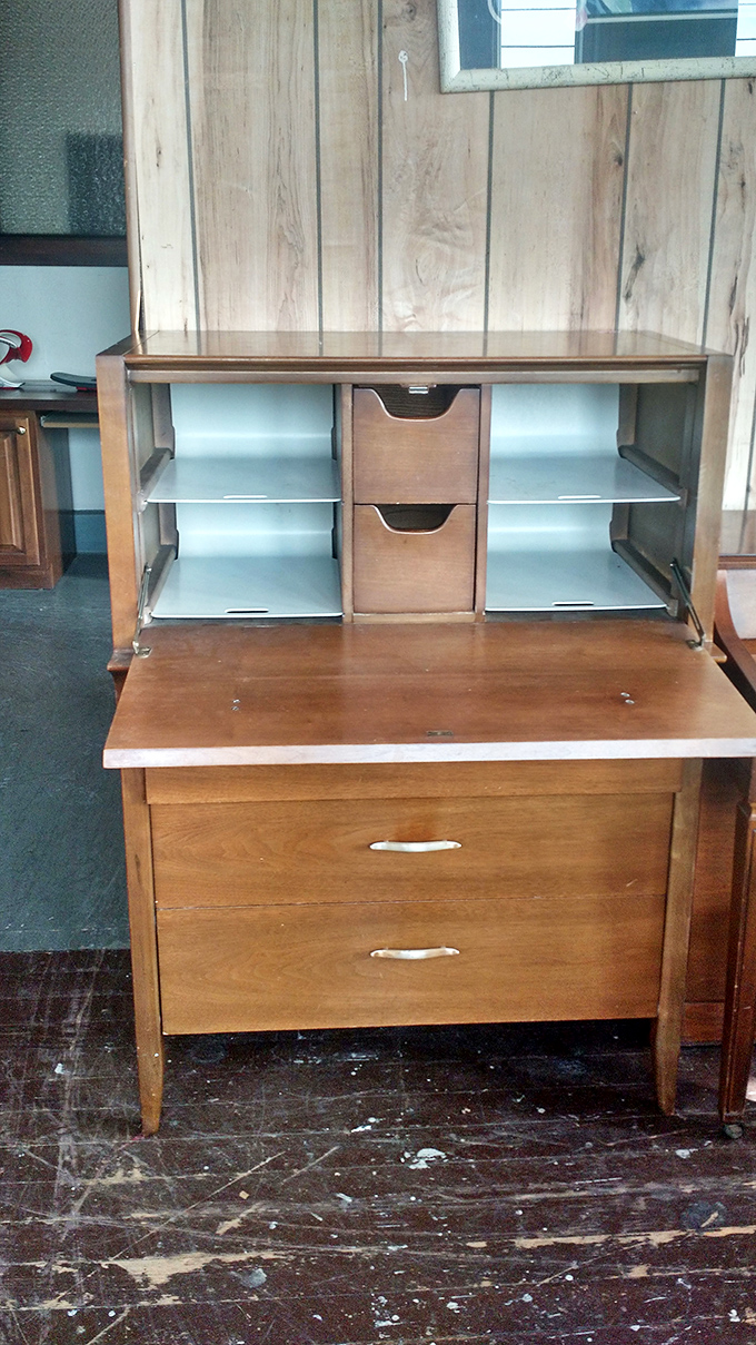 A mid-century secretary desk reveals its clever interior compartments &ndash; the smartphone of furniture from an era when craftsmanship mattered.
