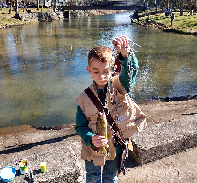 That proud moment when a young angler lands the catch, proving patience and persistence still pay off beautifully.