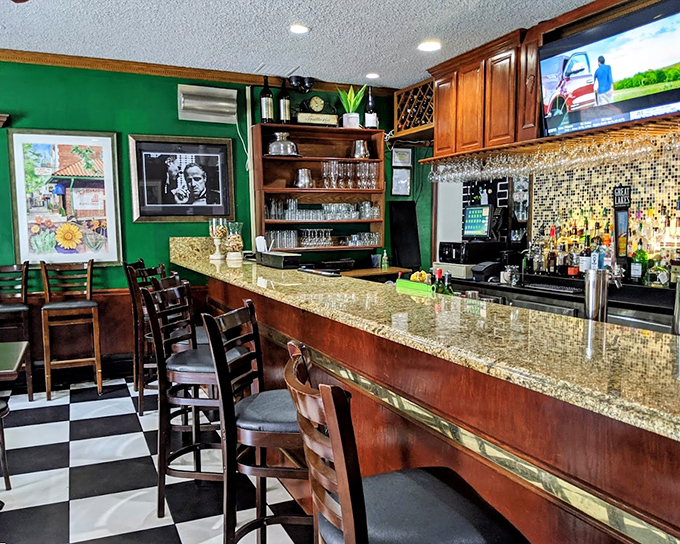 The bar area's rich wood and emerald walls create the perfect backdrop for an aperitivo or digestif. Godfather references optional but encouraged.