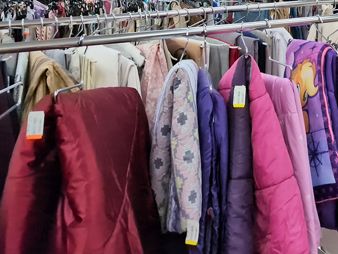 Winter coats and lightweight jackets hang side by side, a seasonal fashion timeline waiting for their next adventure.