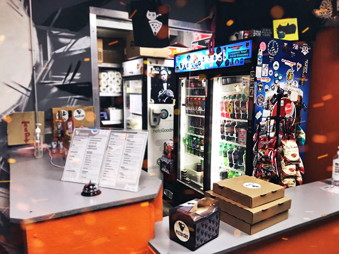 The beverage cooler and snack display stand ready to complement your pizza experience&mdash;necessary companions to Pizza Cat's adventurous flavor combinations.