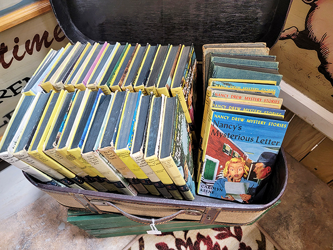 Nancy Drew mysteries stacked like childhood afternoons, waiting to introduce a new generation to the thrill of solving cases with America's favorite teenage sleuth.