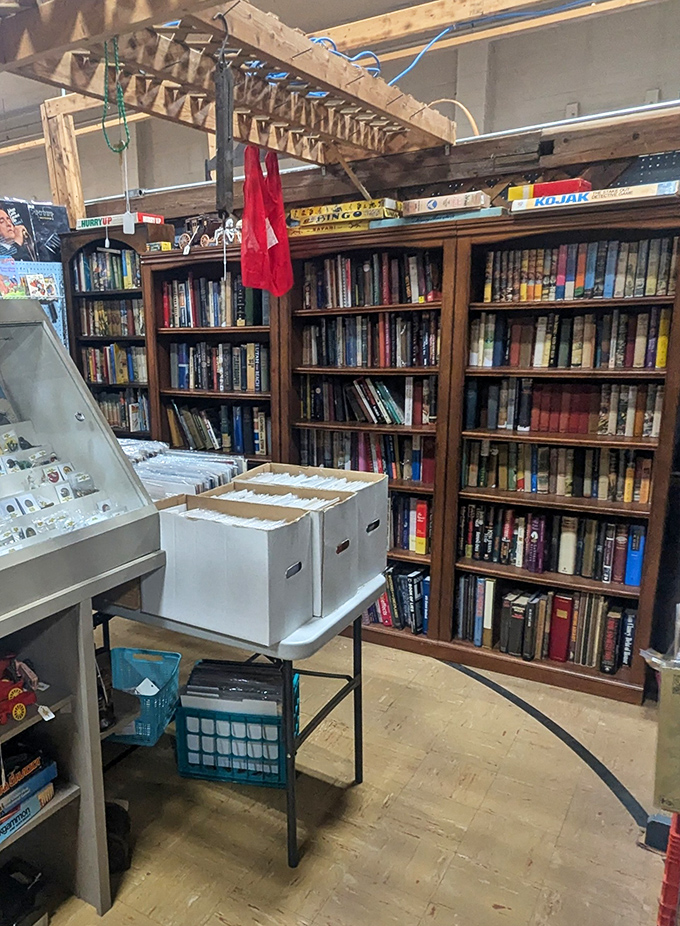A bibliophile's dream corner where vintage books await new homes. Those board games on top might have determined family champions decades ago.