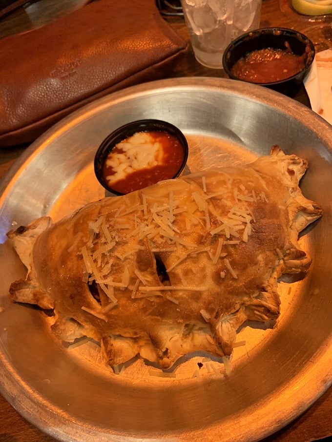 This calzone isn't just dinner&mdash;it's an edible treasure chest filled with melted cheese and savory fillings. The marinara dipping sauce adds the perfect finishing touch.