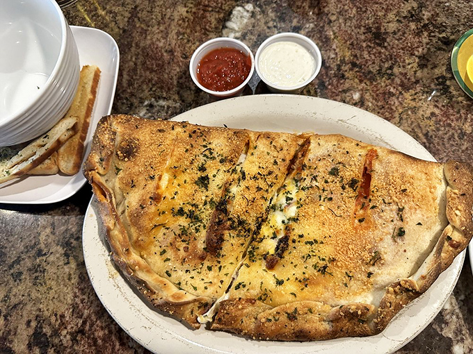 This calzone isn't just big &ndash; it's a commitment, a relationship, a delicious fortress of dough protecting molten cheese and savory fillings.