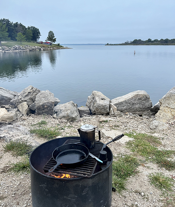 Lakeside dining at its most authentic. This simple fire ring and cast iron setup produces flavors no five-star restaurant can match.