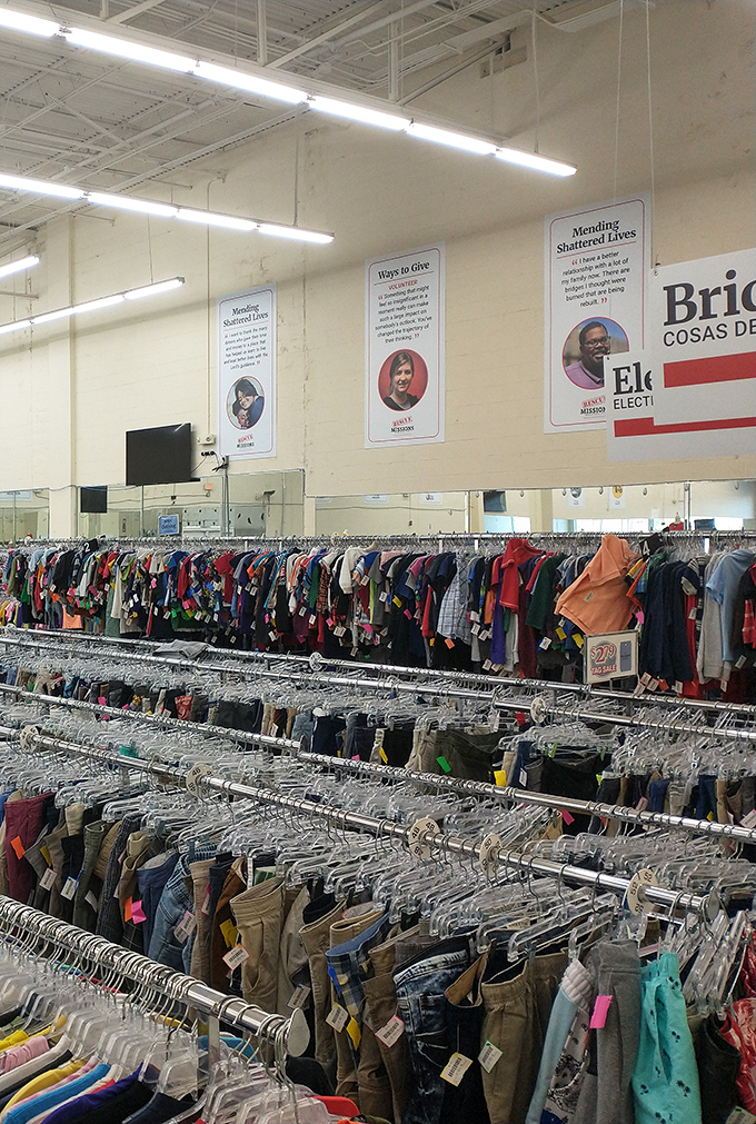 The clothing section stretches to infinity, with inspirational banners above reminding shoppers their purchases support more than just their wardrobes.