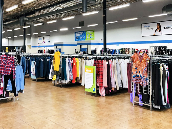 Clothing racks organized by type and color—a rainbow of possibilities. Fashion archaeology at its finest, where patience reveals designer labels at bargain prices.