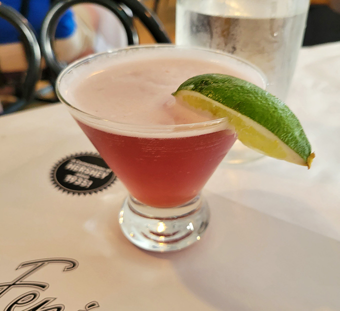 A perfectly pink cocktail with a lime garnish&mdash;because sometimes your drink deserves to dress up too.