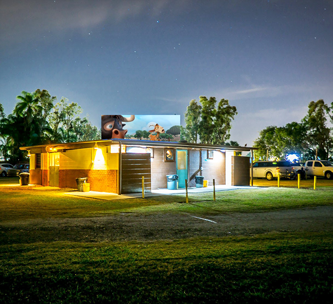 The concession building glows like a beacon in the night, with animated characters on screen keeping watch over snack-seeking moviegoers.