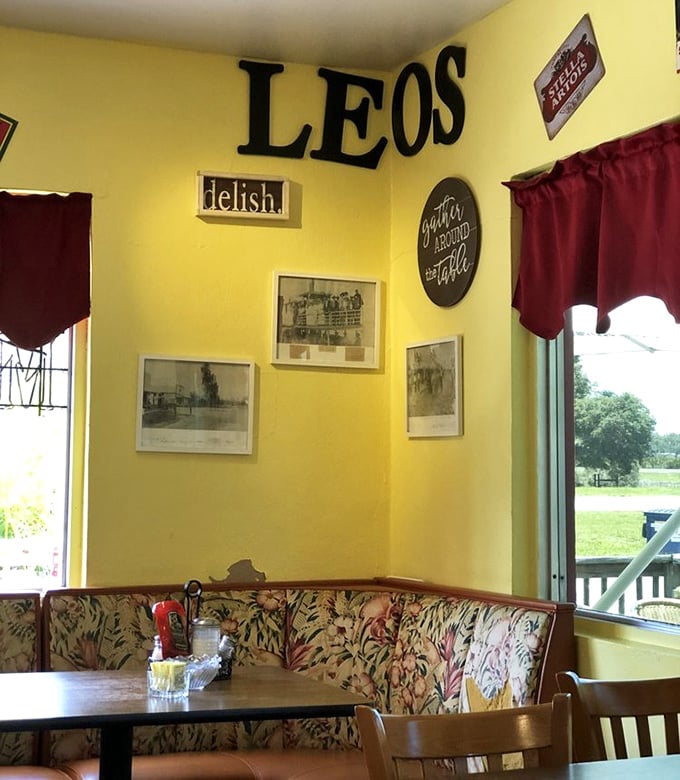 The corner booth at Leo's&mdash;where the "gather around the table" sign isn't just decor, it's the restaurant's entire philosophy.