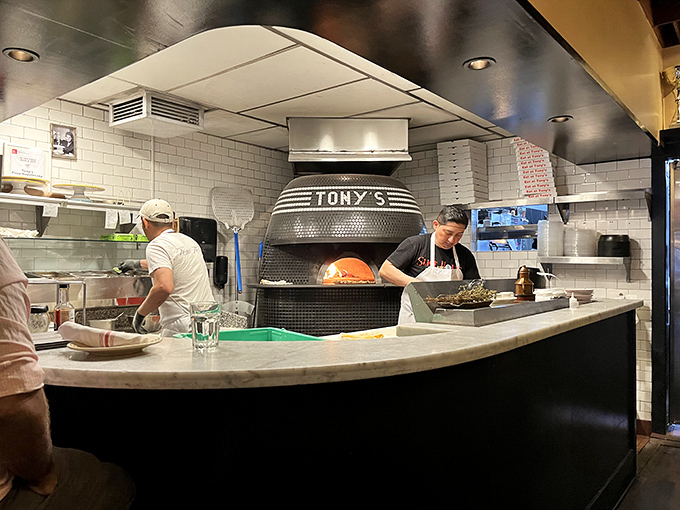 Where pizza magic happens: the gleaming wood-fired oven emblazoned with "TONY'S" is the heart of this pizza paradise.