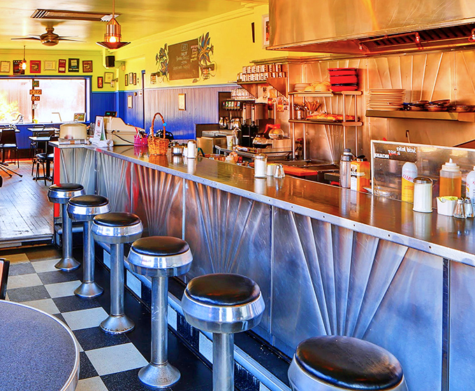 Diner counter seating: where breakfast becomes theater and the stainless steel backdrop frames culinary performances worthy of a standing ovation.