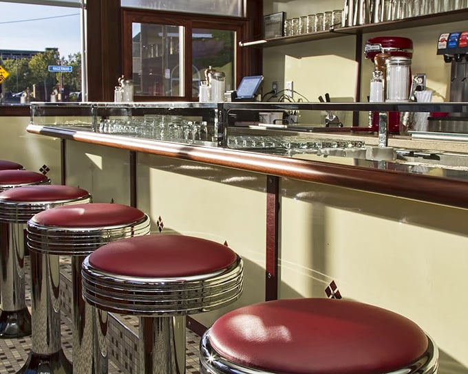 Counter seating that offers the best show in town: breakfast being made with precision and flair. Those red stools have supported more happy diners than a therapist's couch.