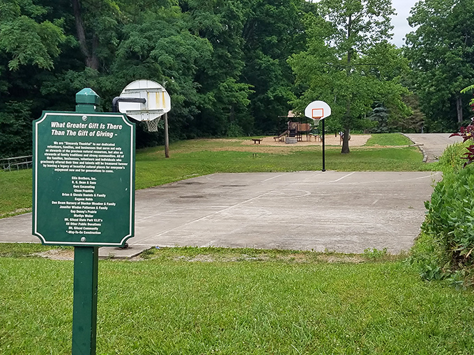 The basketball court and playground sit ready for action, proof that even in nature's embrace, a little friendly competition has its place.