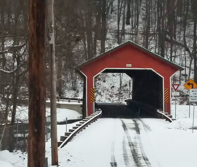 Winter transforms the bridge into a snow-capped passage that looks straight out of a holiday movie set.