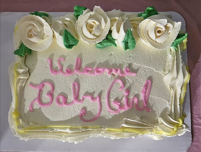 Custom cakes that tell your story in buttercream. This baby girl welcome cake says "We celebrate life's beginnings with proper amounts of sugar."