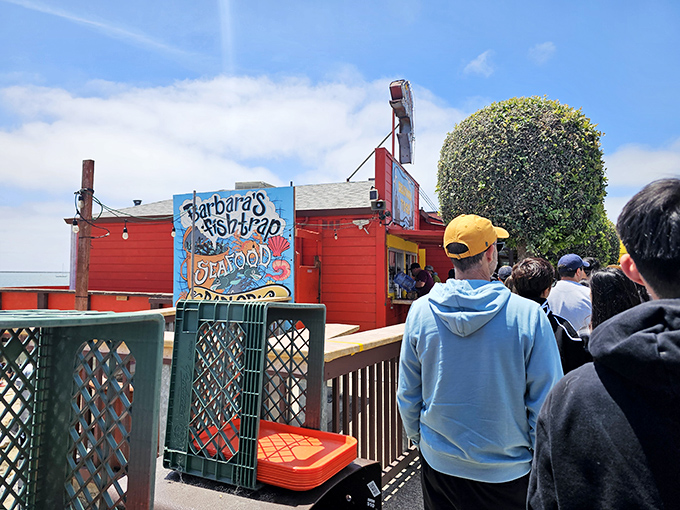 When people line up outside a seafood shack, you know something special's happening inside those bright red walls.