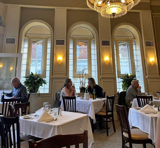 The dining room at dusk becomes a theater where the real stars aren't on the walls but on the plates arriving from the kitchen's well-orchestrated chaos.