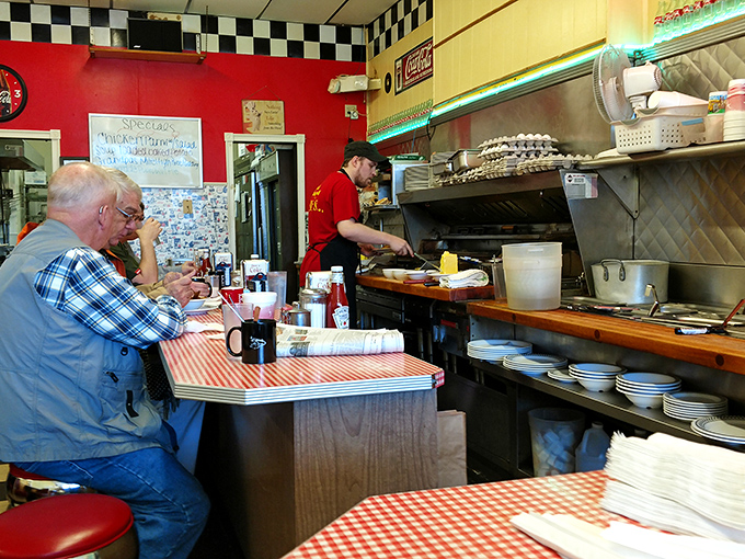 Morning philosophers gather at the counter, where coffee refills flow freely and the griddle soundtrack provides the perfect backdrop for solving the world's problems. 