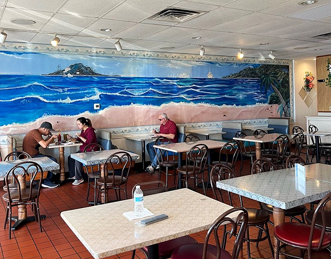 A seaside mural transports diners to coastal Vietnam, proving you can indeed take a vacation during your lunch break—no passport required.