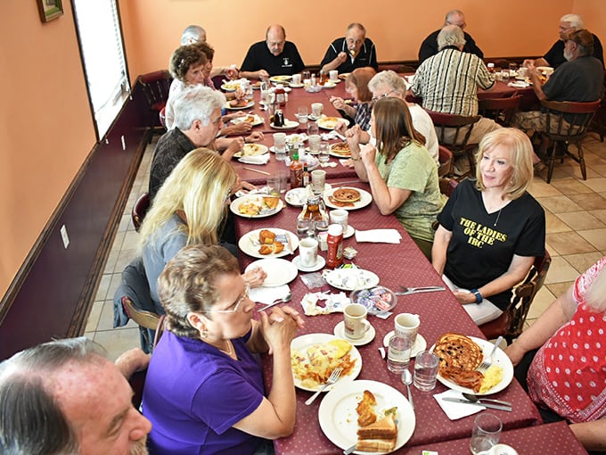 Large groups gather around tables filled with breakfast favorites, proving this spot knows how to feed a hungry crowd right.