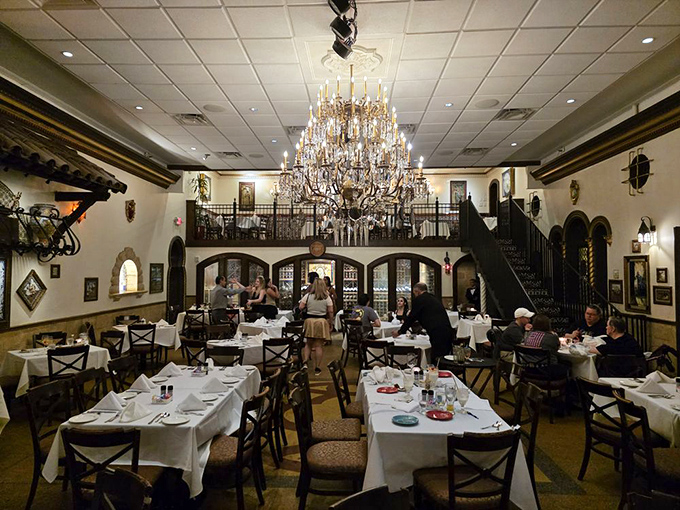 Two-story elegance with a chandelier that's witnessed countless proposals, anniversaries, and "I can't believe how good this paella is" moments.