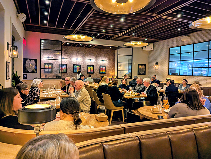 Diners lean in over plates of pasta, engaged in that universal ritual of "you have to try this" that turns strangers into co-conspirators in deliciousness.
