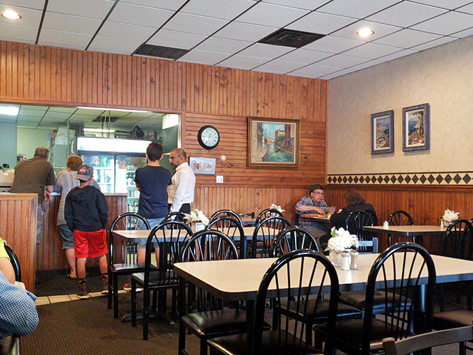 A glimpse into the dining area reveals the secret ingredient of any great neighborhood restaurant: tables filled with people making memories over meals.