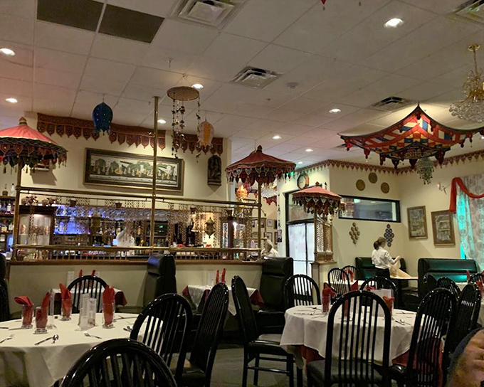 The dining area's decorative umbrellas and hanging ornaments create intimate spaces where conversations flow as freely as the flavors.