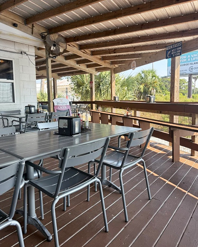 The covered patio offers a perfect Florida dining experience: casual seating, gentle breezes, and the promise of seafood that was swimming this morning.