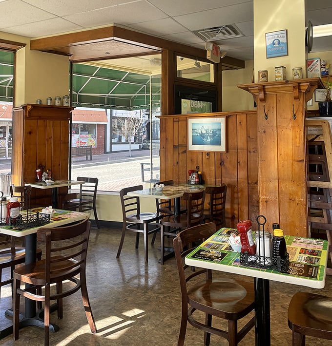 Sunshine streams through windows illuminating wooden charm. The dining area feels like it's been waiting just for you, with each table promising its own perfect breakfast experience. 