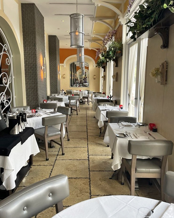 The dining room's elegant corridor creates an intimate atmosphere where every table feels like the best seat in the house.