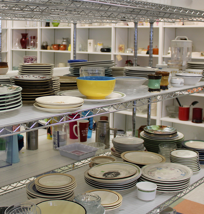 Dishes and bowls stacked like edible archaeology, each piece with its own dinner party history.