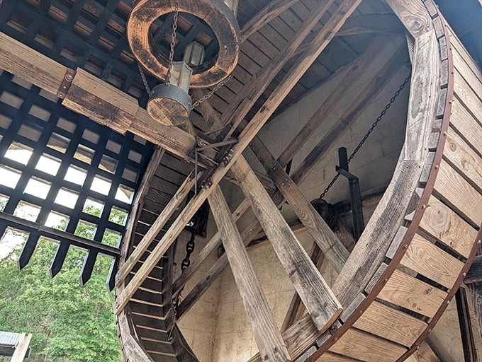 The authentic drawbridge mechanism showcases medieval engineering prowess with massive wooden beams and iron chains.