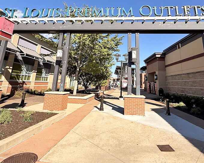 The grand entrance arch stands like a retail Colosseum, promising gladiatorial combat between your budget and your shopping desires.