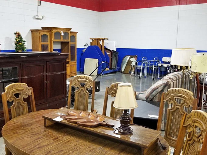 Solid wood dining sets and vintage cabinets stand like furniture islands, each piece whispering "they don't make 'em like this anymore."