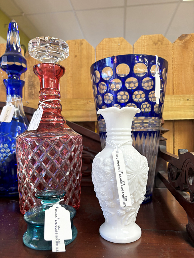Crystal and glassware catch the light like diamonds in a mine&mdash;cobalt blue decanters and milk glass vases waiting for their second act on someone's table.