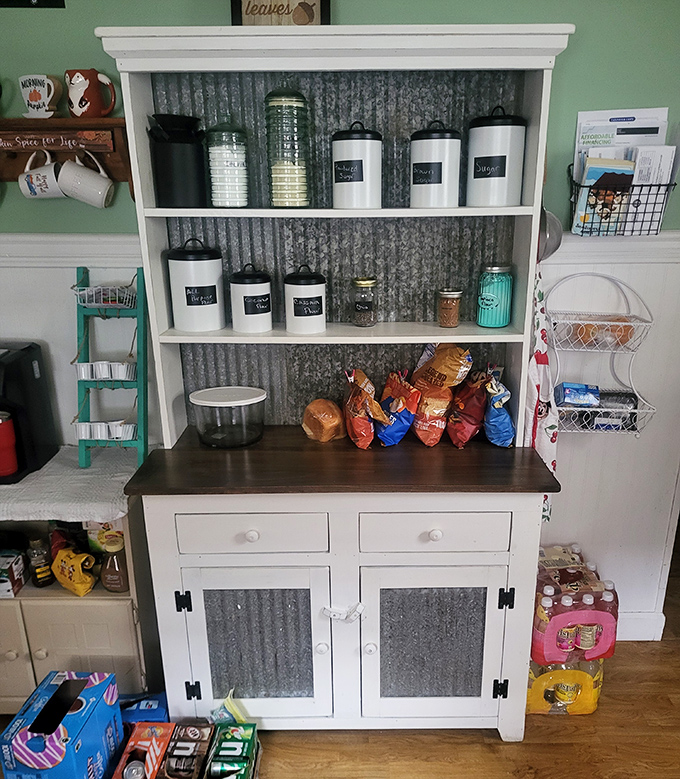 Farmhouse chic meets practical storage in this charming hutch. That corrugated metal backing is the design element you didn't know your kitchen needed.