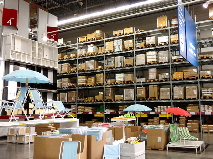 An IKEA-esque warehouse section with beach umbrellas and summer furniture on display. Paradise in flat-pack form, just add Allen wrench and patience.