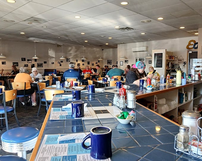 The bustling dining room where regulars don't need menus and newcomers become regulars. Blue mugs stand ready for the lifeblood of diner culture&mdash;endless coffee.