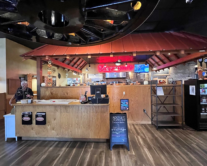 The host station welcomes you with rustic wood paneling and that glowing sign&mdash;the gateway to your impending food coma.