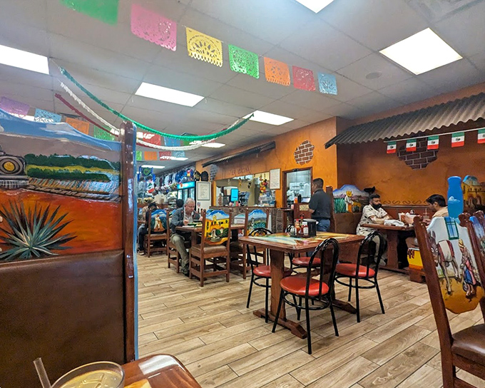 Colorful papel picado banners flutter overhead like Mexican prayer flags, blessing every bite taken beneath them. The atmosphere is as authentic as the food. 