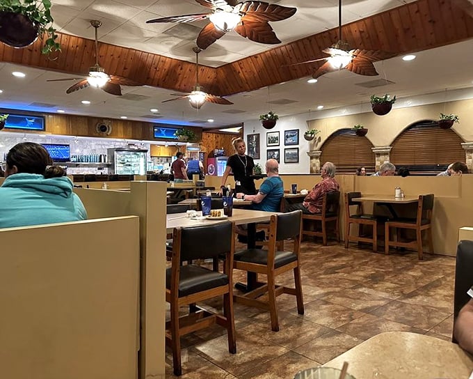 Tropical ceiling fans spin lazily above wooden booths where breakfast memories are made. Florida diner perfection in its natural habitat.