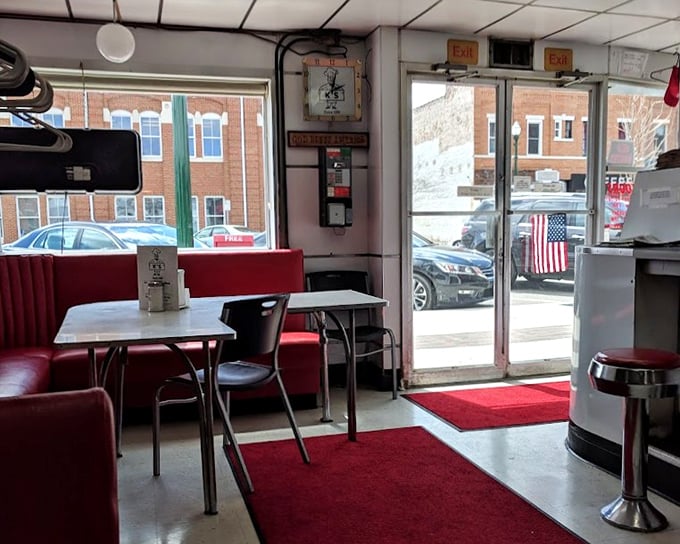 A diner where Norman Rockwell would feel right at home. Red booths, American flags, and the promise of honest food.