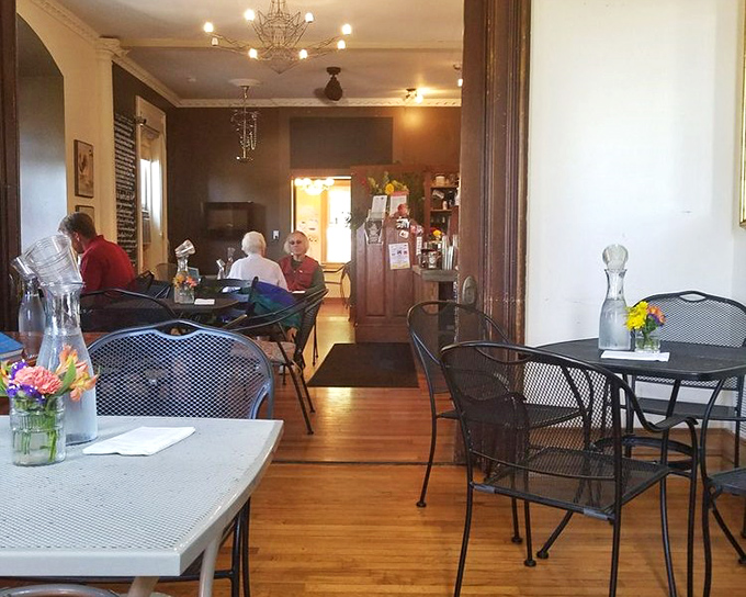 Hardwood floors and wrought iron seating create a European caf&eacute; vibe. Fresh flowers on each table&mdash;because details matter here.