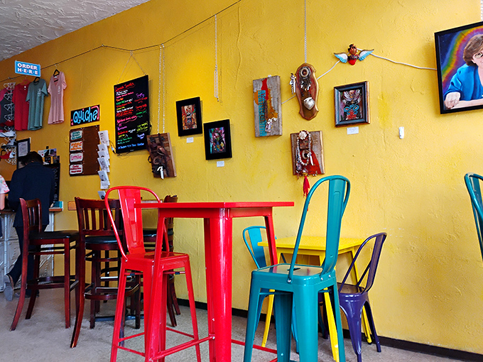 Colorful chairs that pop against sunshine walls&mdash;this isn't just interior design, it's visual caffeine. Art gallery meets comfort zone in the best possible way.